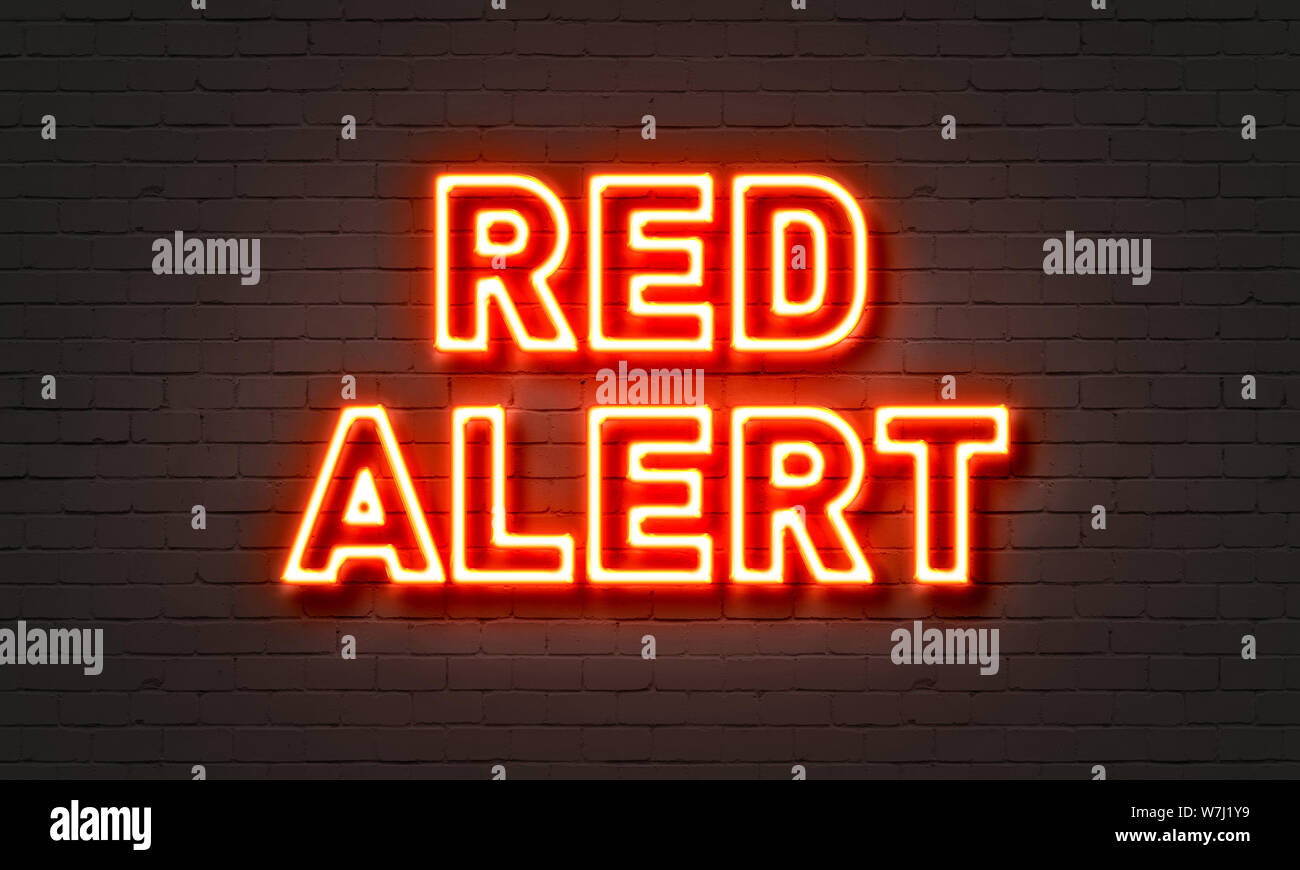 Red alert neon sign on brick wall background Stock Photo - Alamy