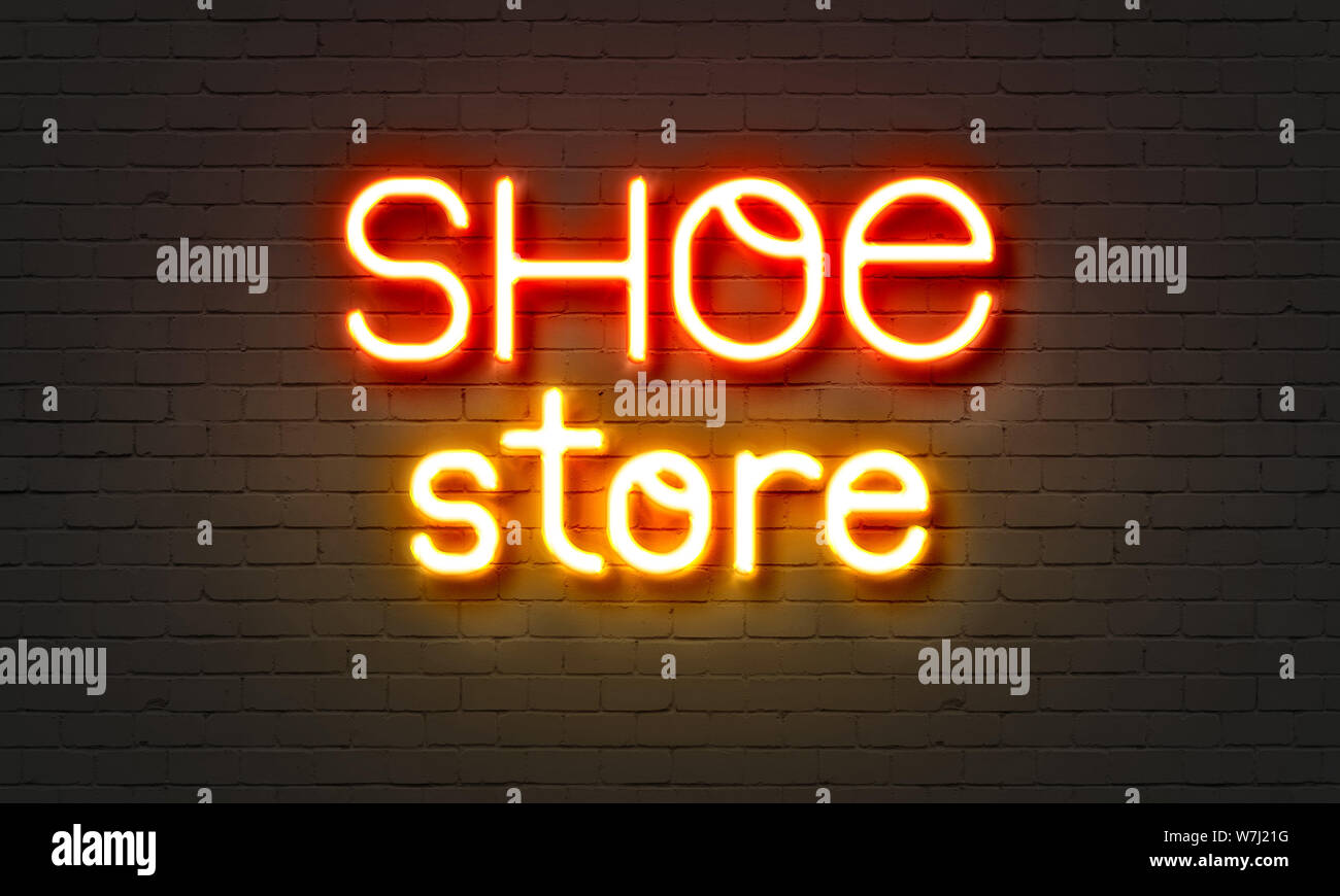 Shoe store neon sign on brick wall background Stock Photo - Alamy
