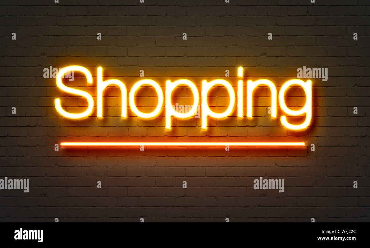 Shopping neon sign on brick wall background Stock Photo - Alamy