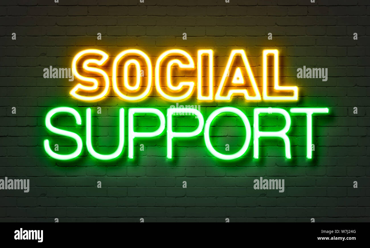 Social support neon sign on brick wall background Stock Photo - Alamy