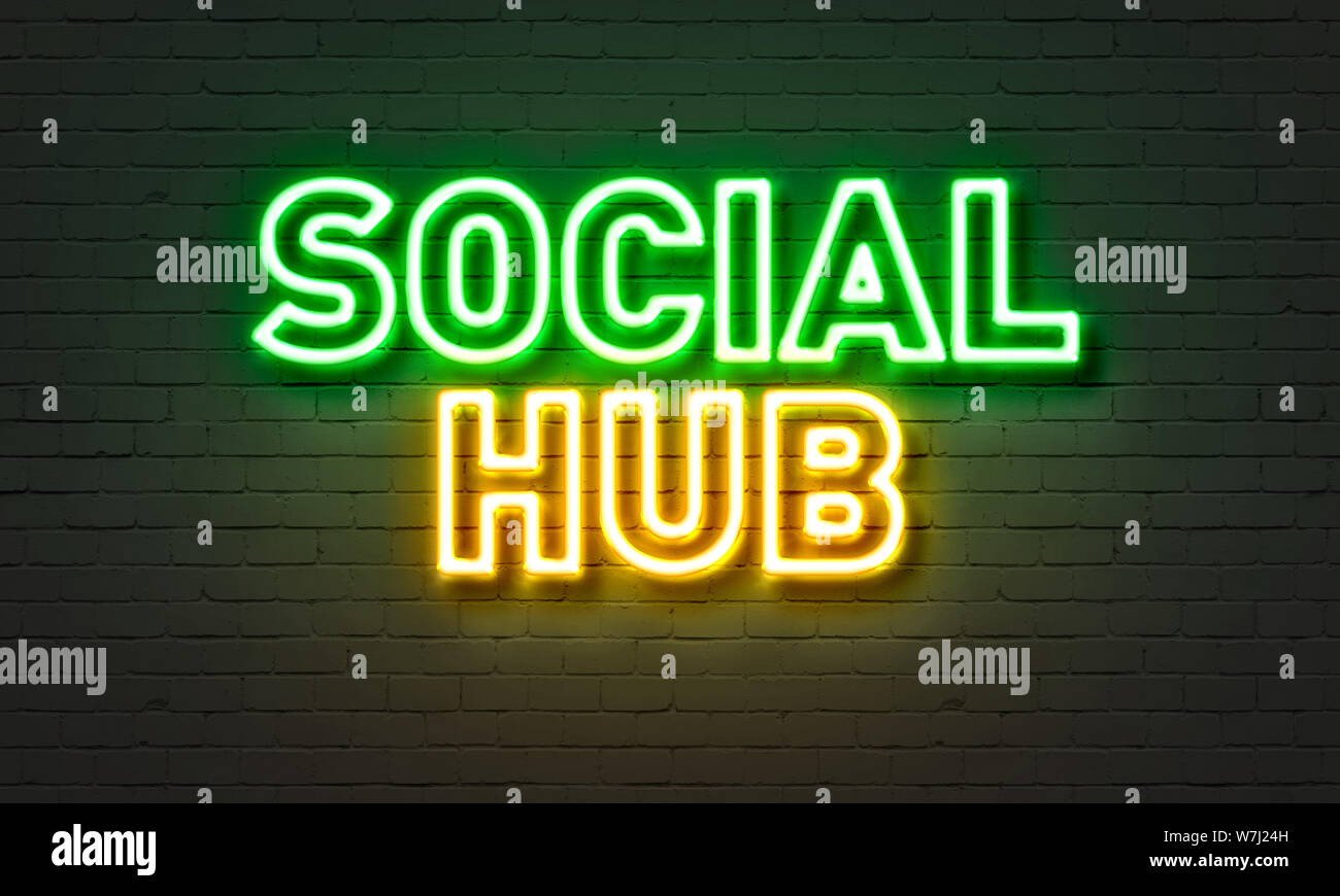 Social hub neon sign on brick wall background Stock Photo - Alamy