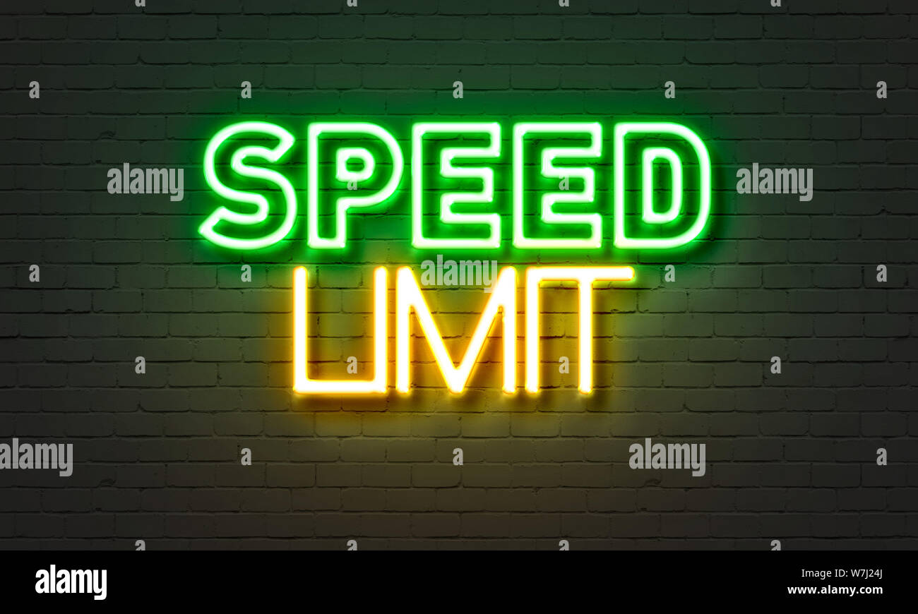 Speed limit neon sign on brick wall background Stock Photo - Alamy