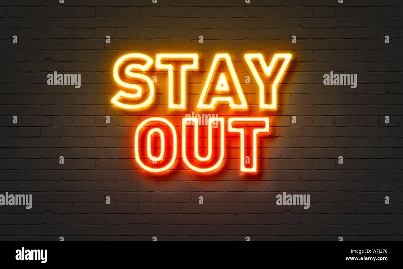 Stay out neon sign on brick wall background Stock Photo - Alamy
