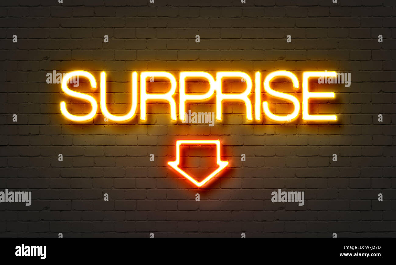 Surprise neon sign on brick wall background Stock Photo - Alamy