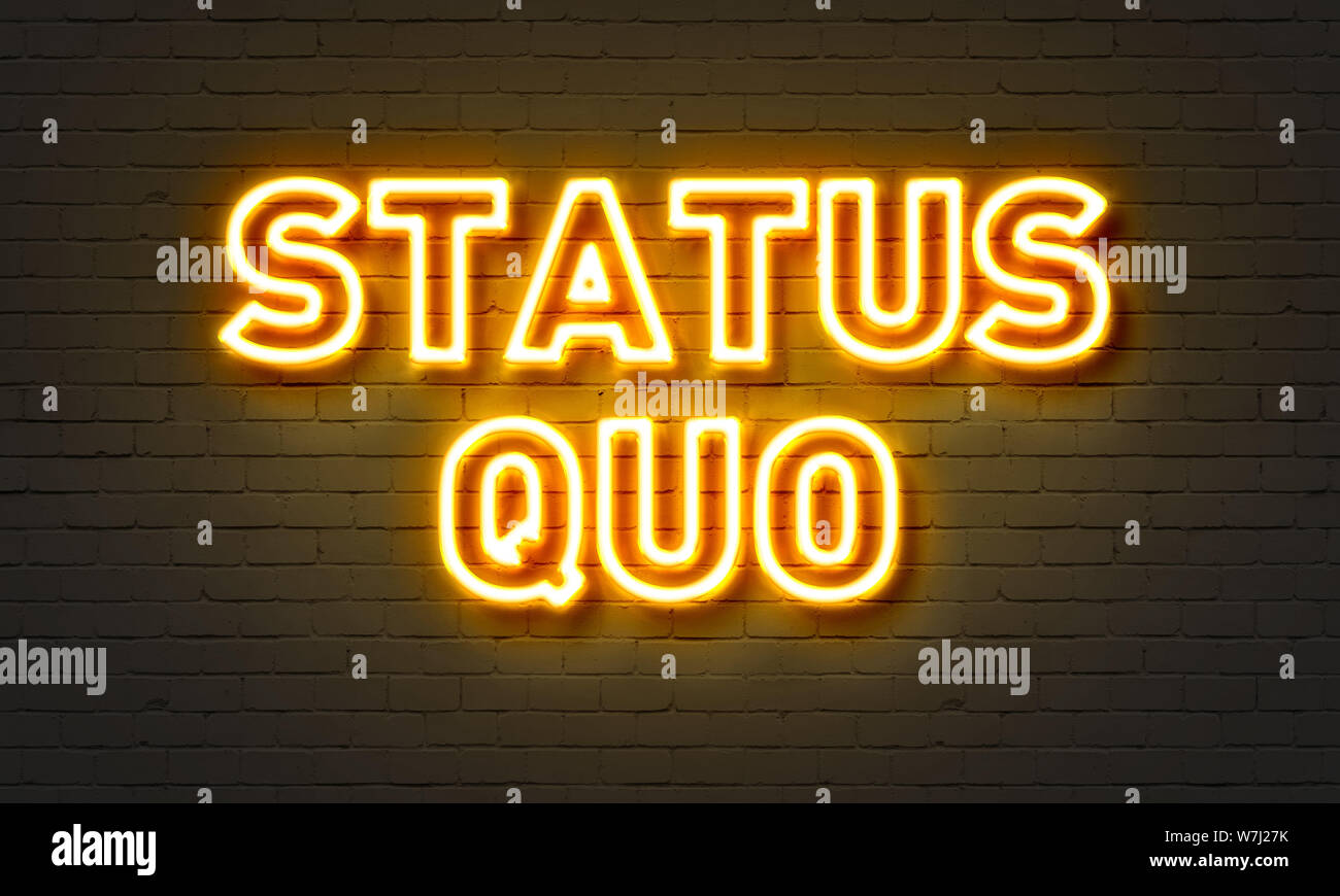 Status quo neon sign on brick wall background Stock Photo - Alamy