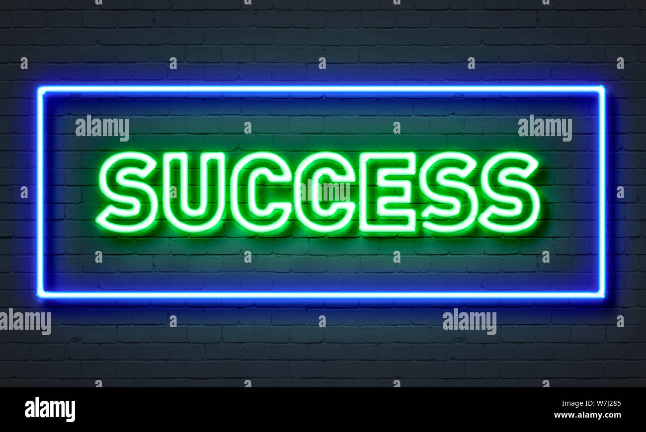 Success neon sign on brick wall background Stock Photo - Alamy