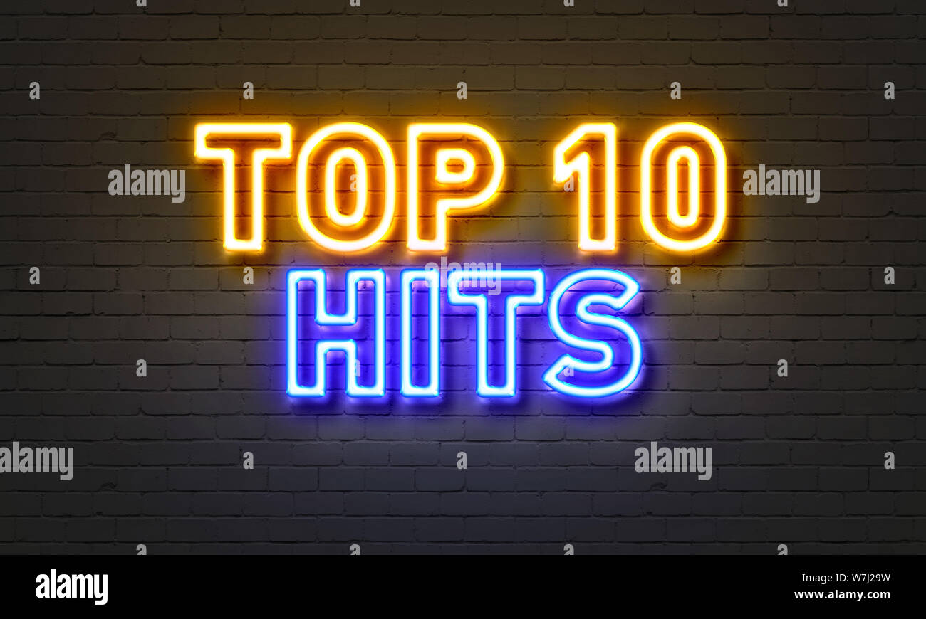 Top 10 hits neon sign on brick wall background Stock Photo - Alamy