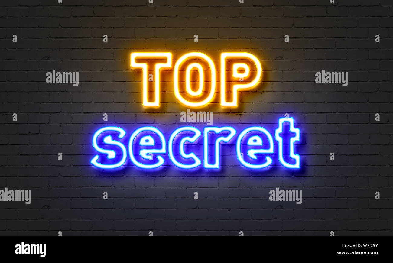 Top secret neon sign on brick wall background Stock Photo - Alamy