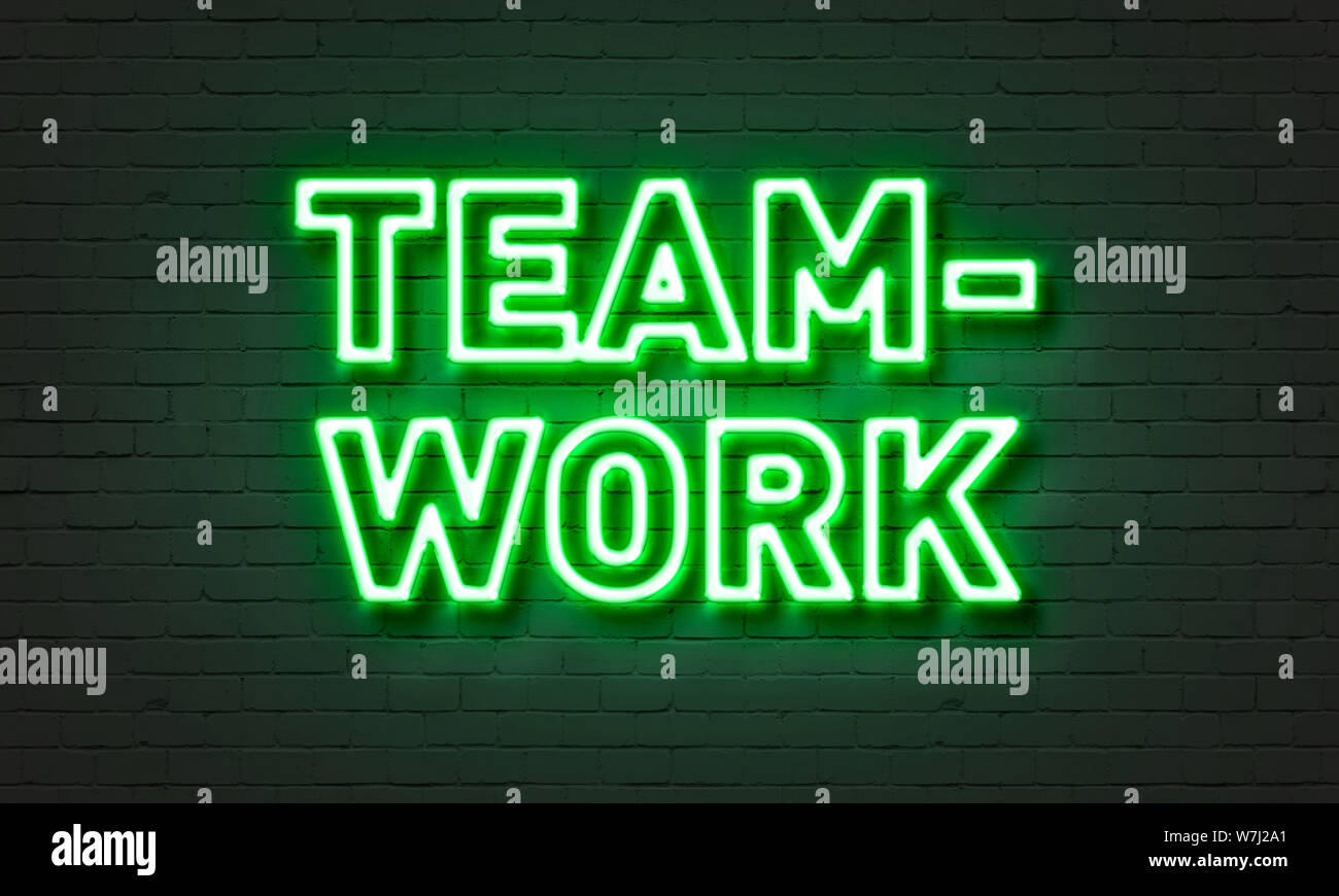 Teamwork neon sign on brick wall background Stock Photo - Alamy