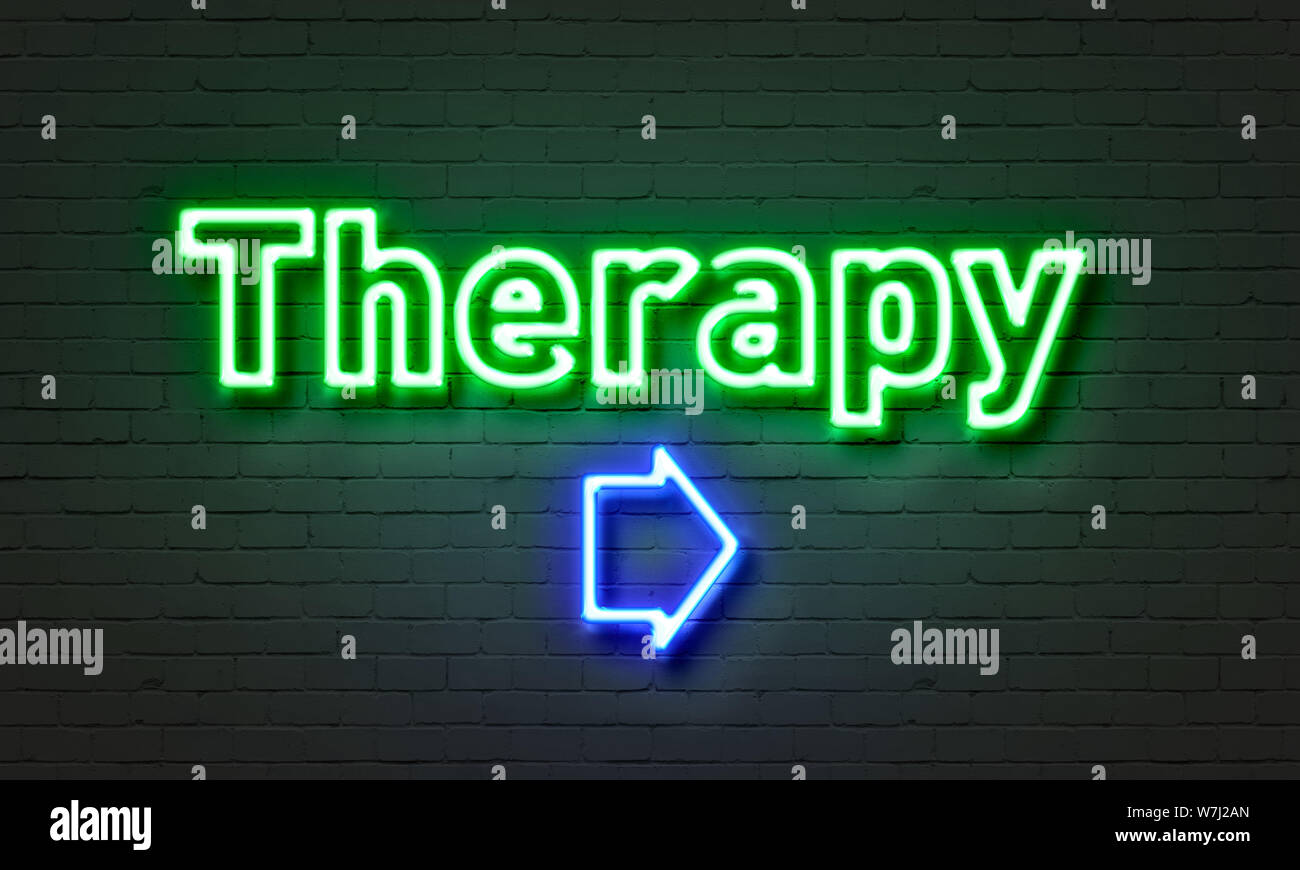 Therapy neon sign on brick wall background Stock Photo - Alamy