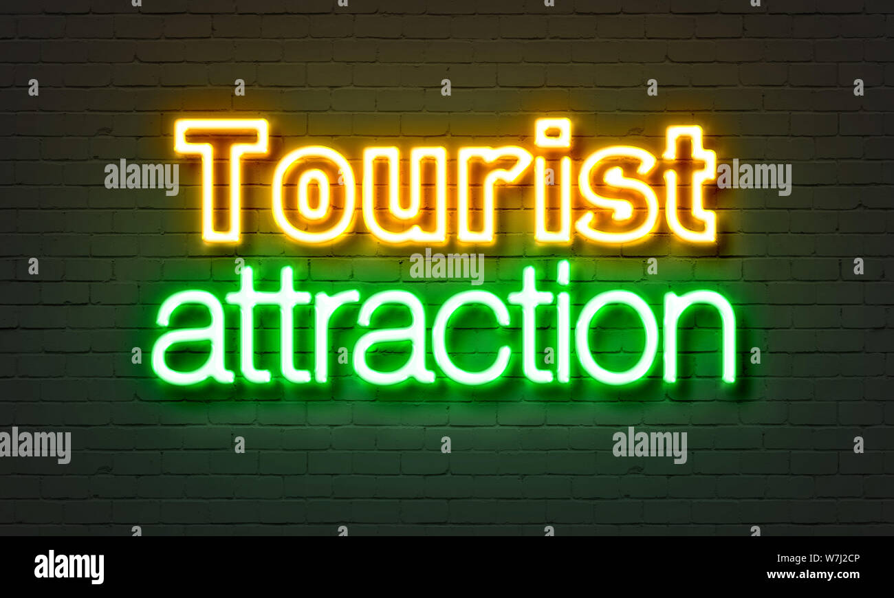 Tourist attraction neon sign on brick wall background Stock Photo - Alamy