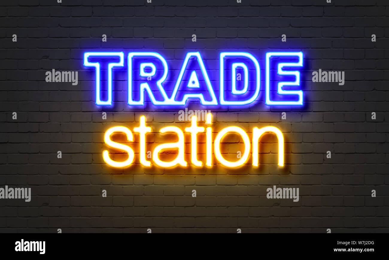 Trade station neon sign on brick wall background Stock Photo - Alamy