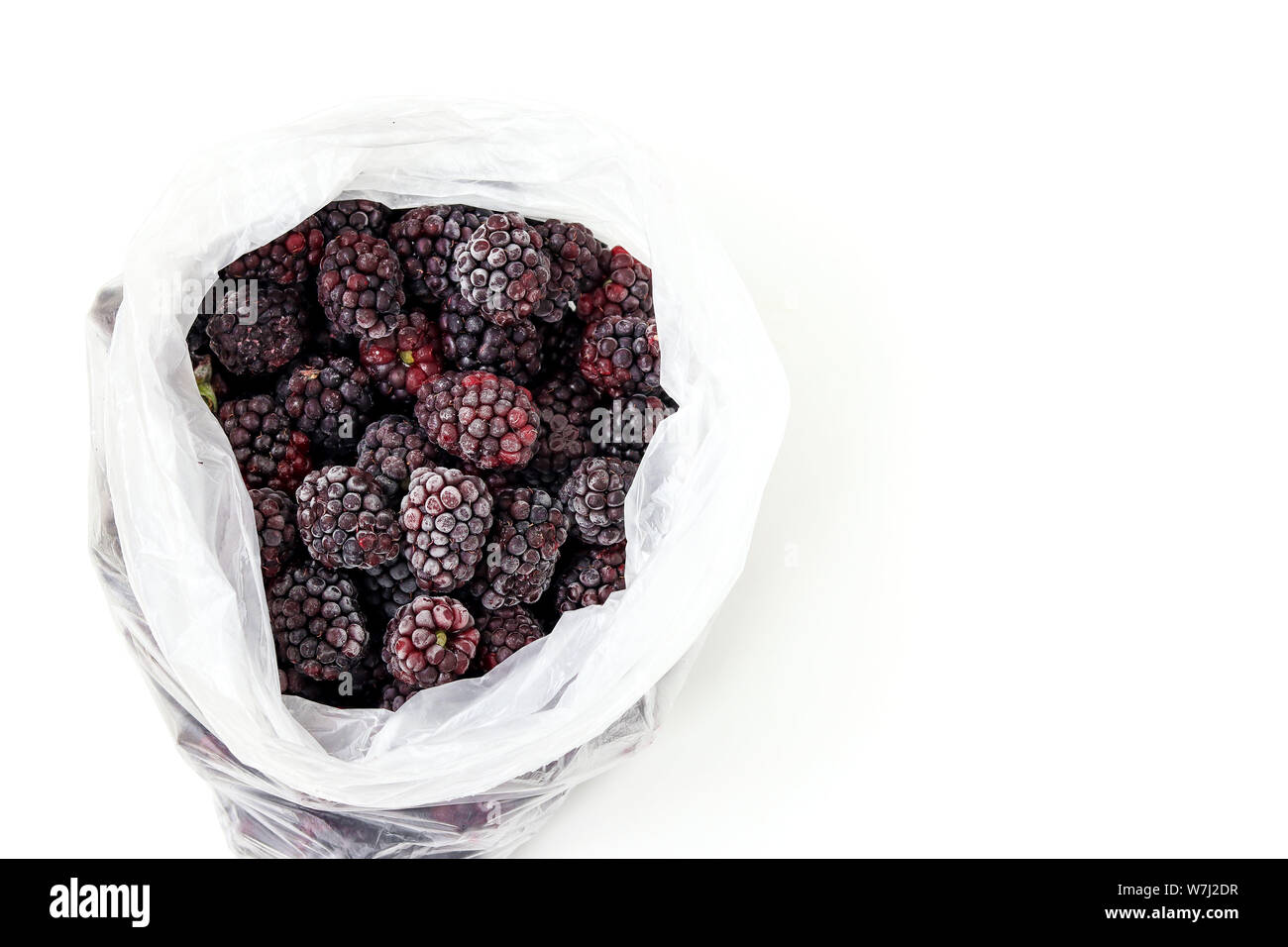 Frozen organic blackberry located in transparent package on awhite ...
