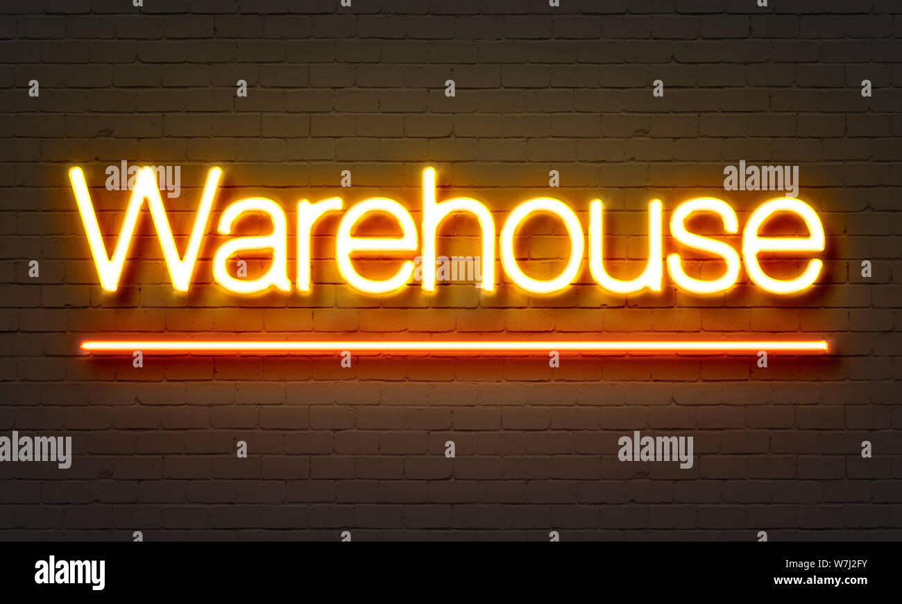 Warehouse neon sign on brick wall background Stock Photo - Alamy