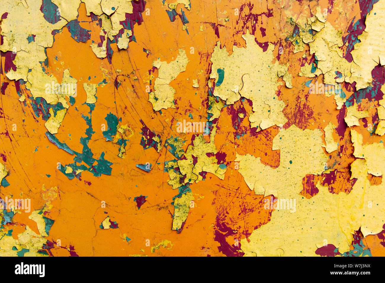 rusty metal sheet with peeling layers of paint of different colours - a ...