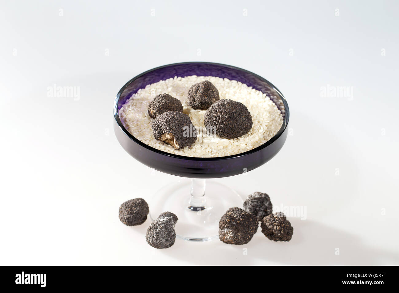 Black Truffles in rice on a white background Stock Photo - Alamy