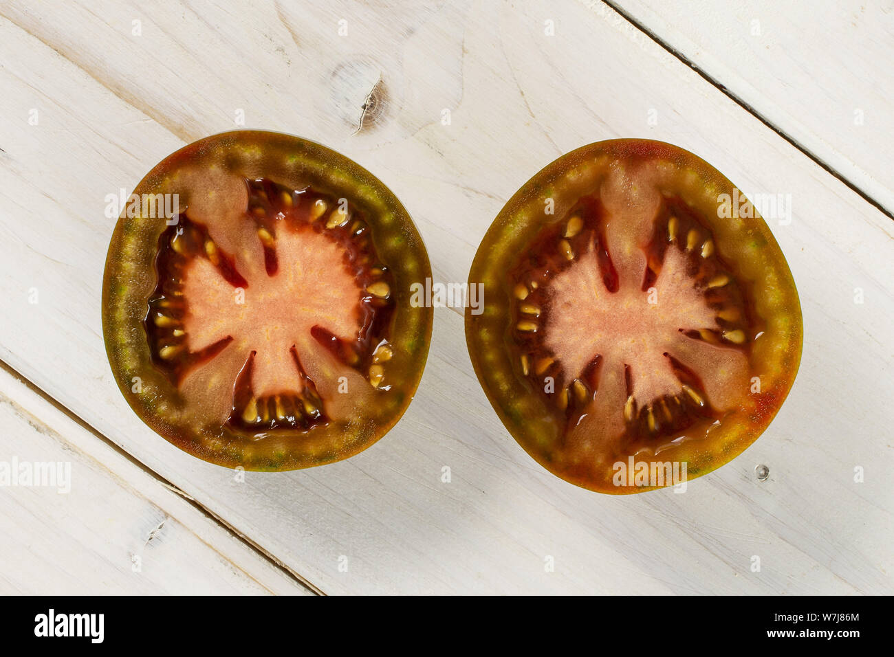 Group of two halves of fresh greenish red tomato cross section flatlay ...