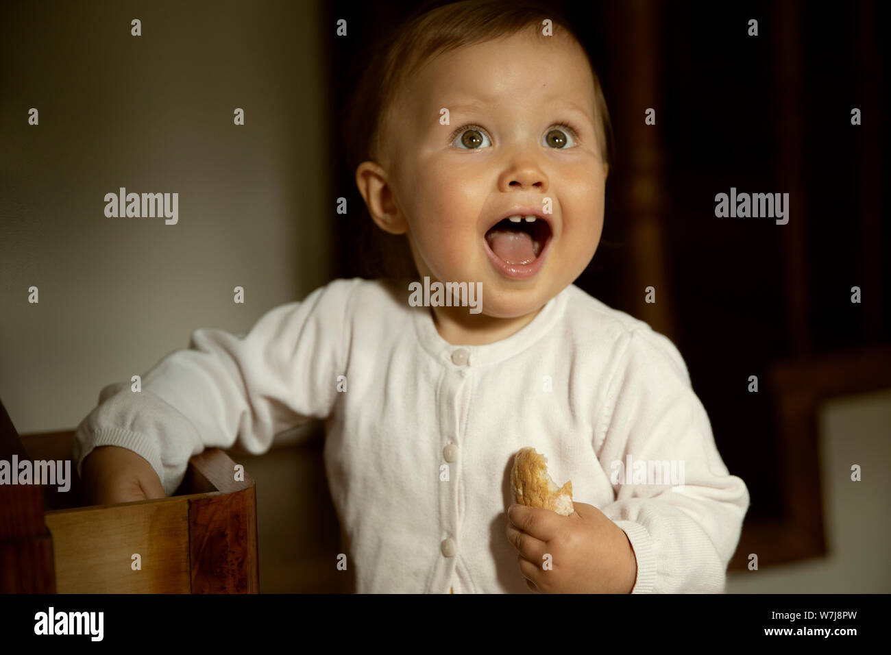 Funny baby surprised after finding something in a drawer Stock Photo ...
