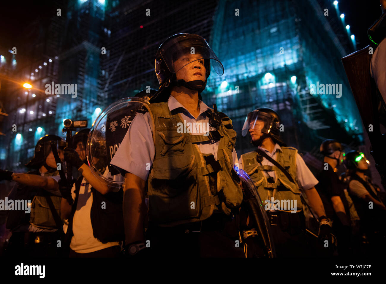 Riot police officers stand on guard during the clashes with the ...