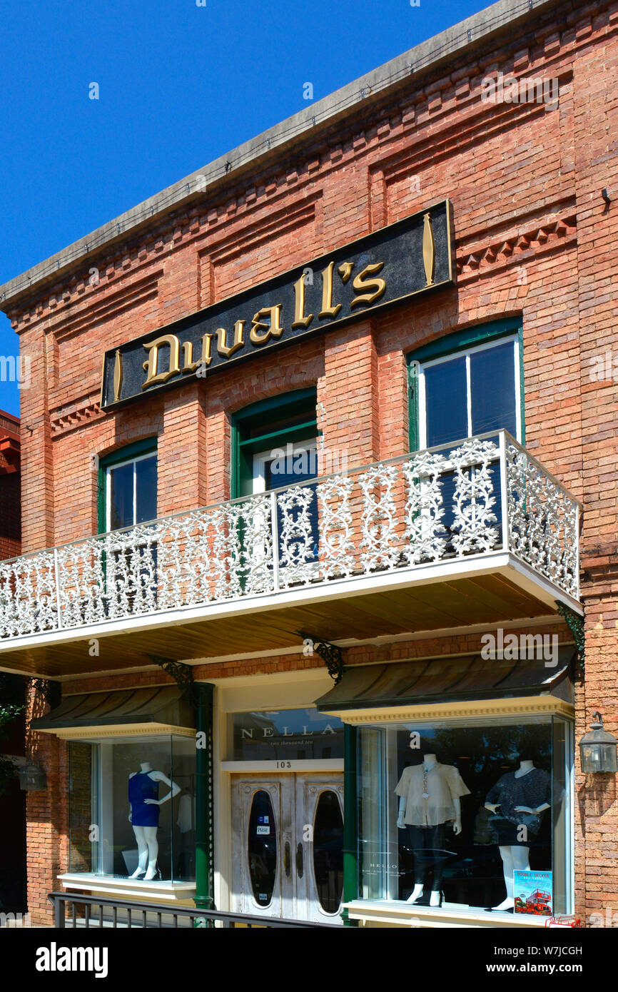A historic two storied commercial brick building with a decorative iron ...