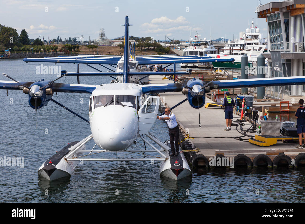 Pilot climbing aboard his Twin Otter Seaplane in Victoria Harbour ...