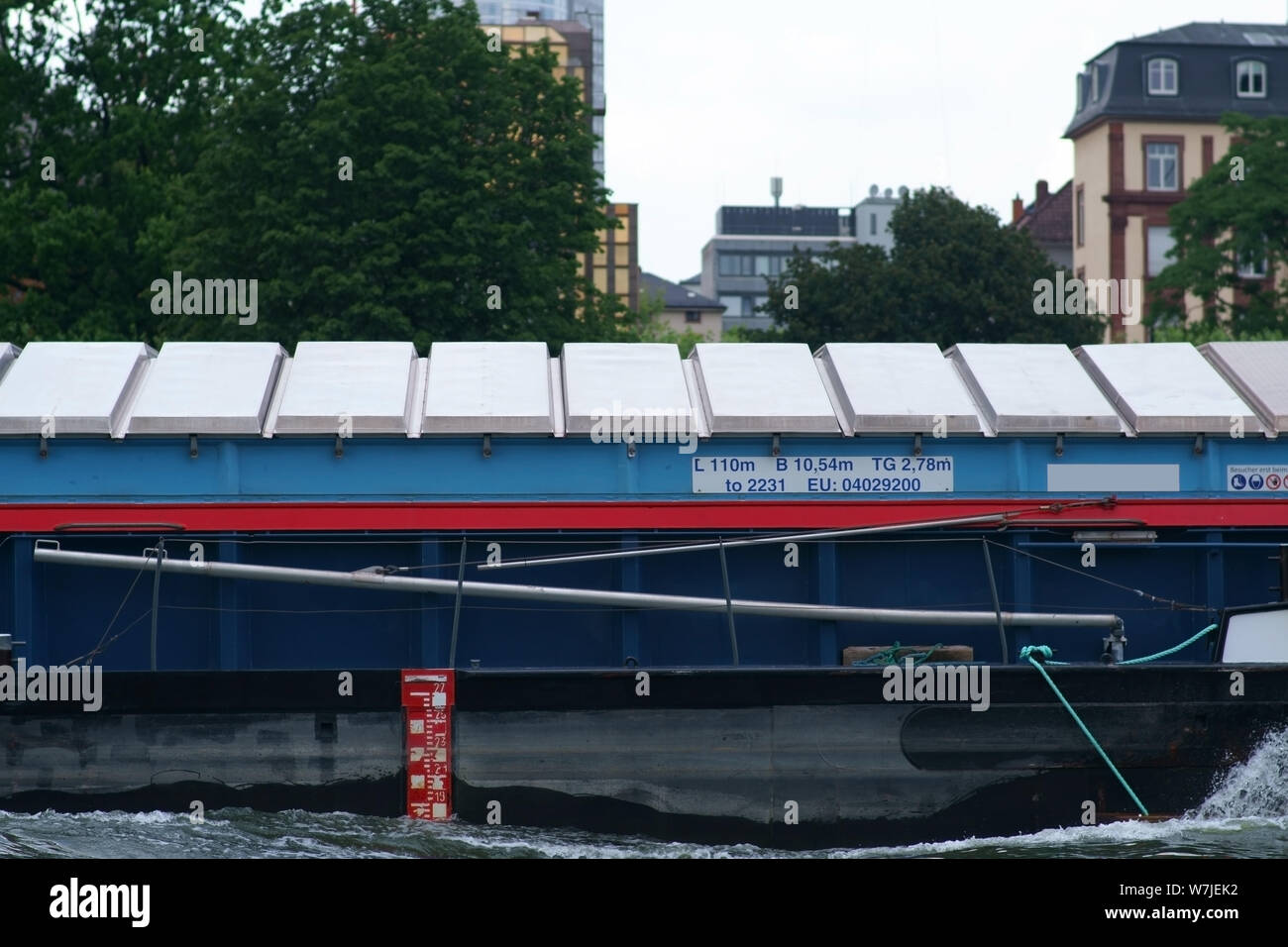 The side view of a container ship on a river Stock Photo - Alamy