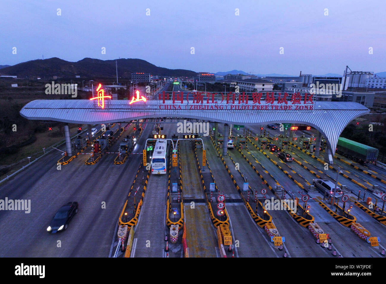 --FILE--Vehicles pass through a toll station on an expressway to get ...