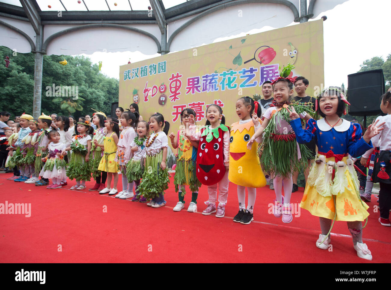 Children display the ''clothes'' made of vegetables and fruits at a ...