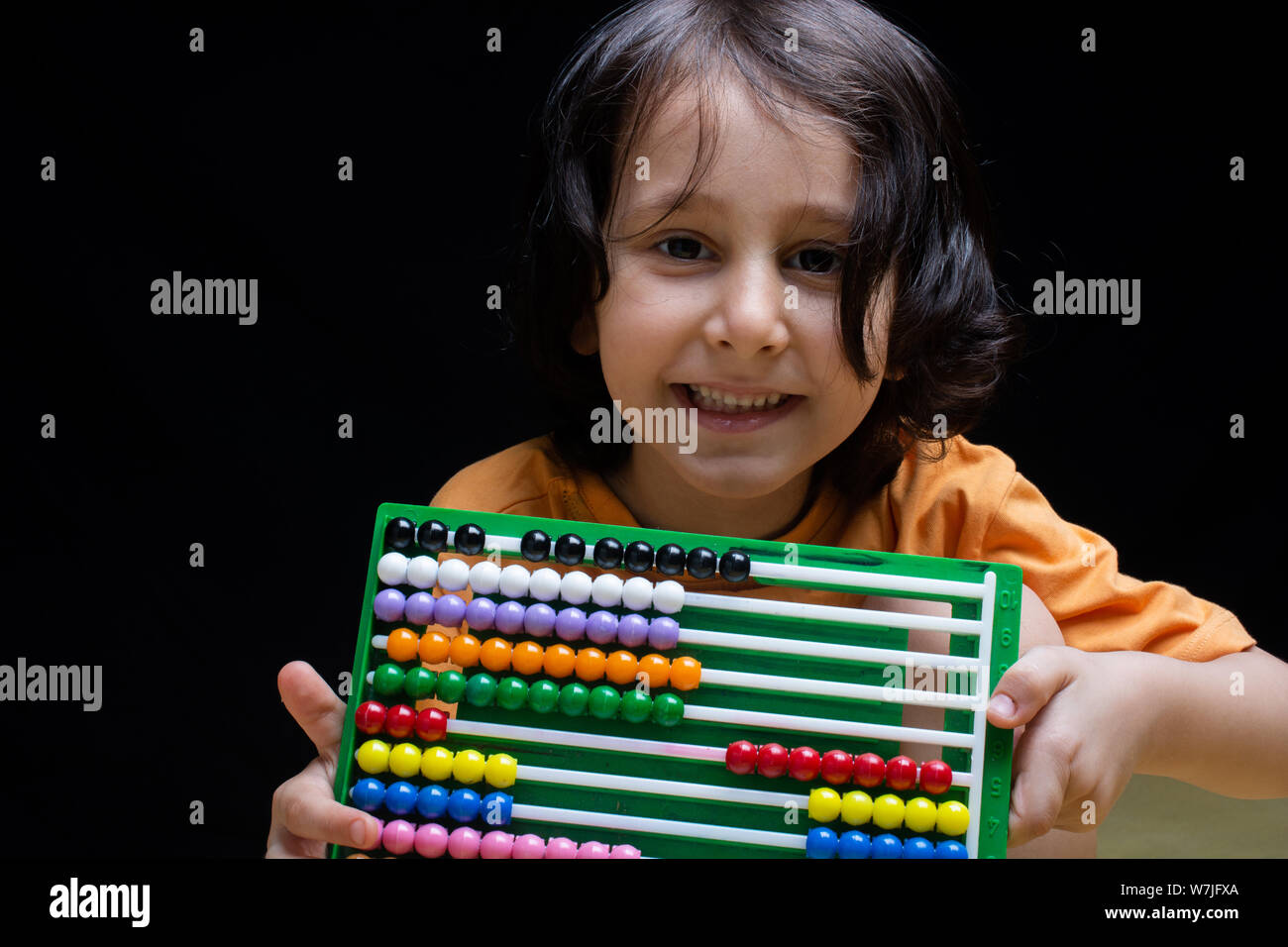 Portrait of a cute happy smiling boy with abacus in hand Stock Photo ...
