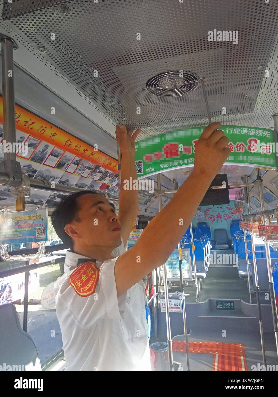 Chinese bus driver Yang Hongtao checks a solar-powered air purifier ...