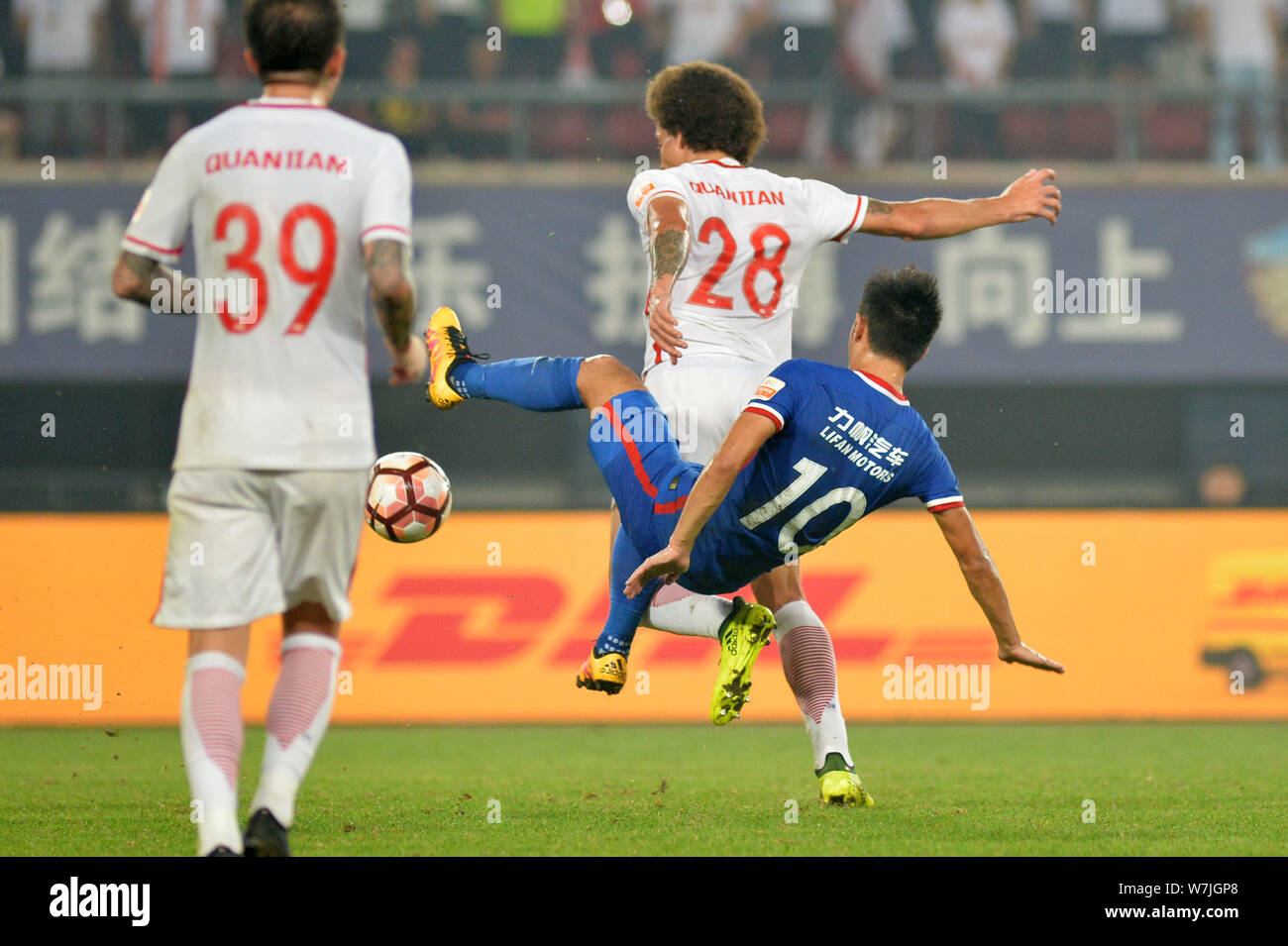 Belgian football player Axel Witsel, left, of Tianjin Quanjian kicks ...