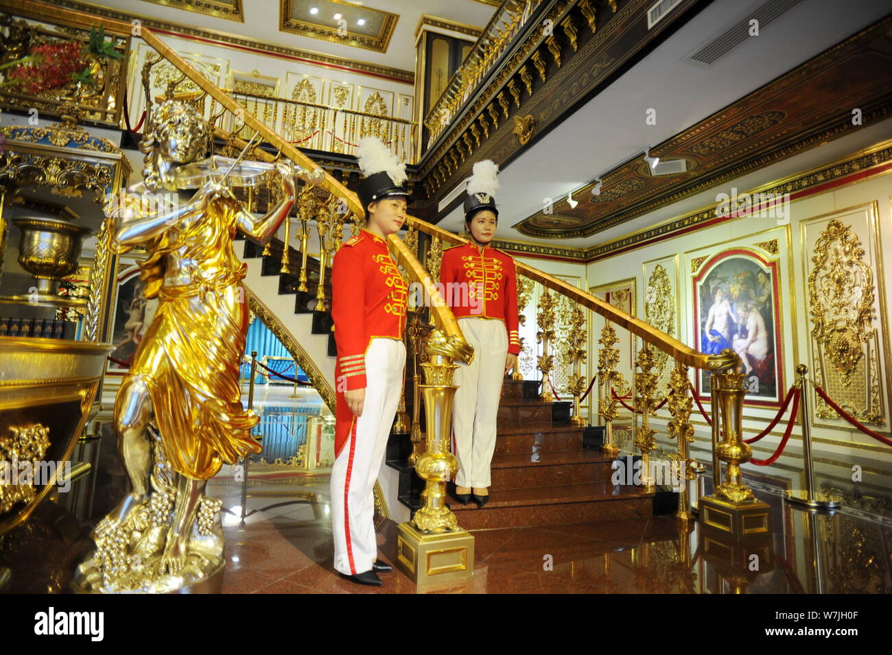 Chinese employees dressed in royal palace servant costumes pose in a ...