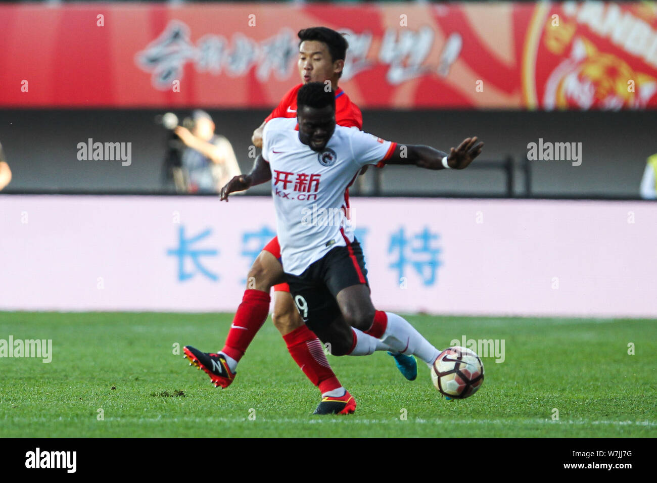 Cameroonian football player Olivier Boumal, front, of Liaoning Whowin ...