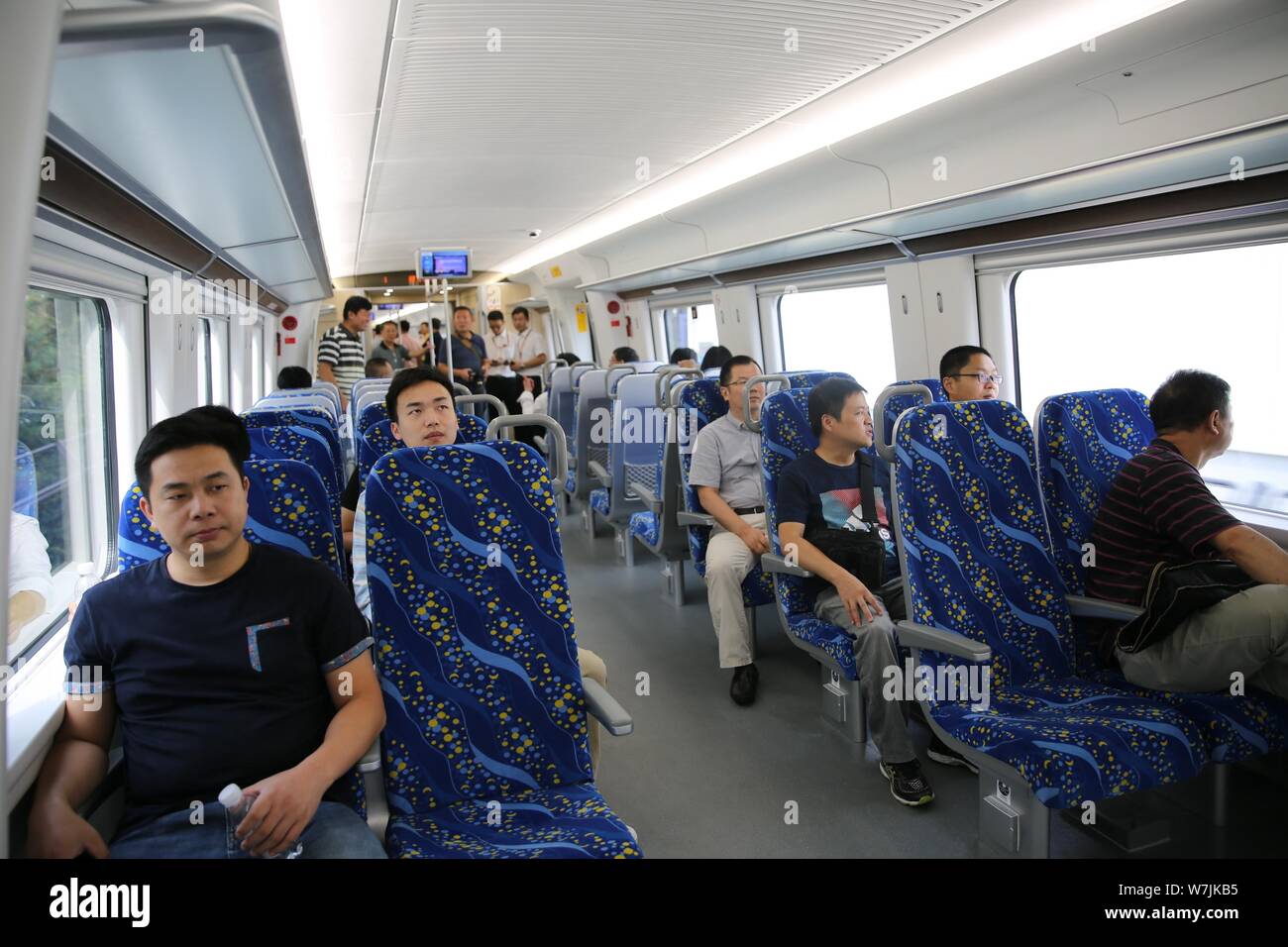 Passengers sit in a CRH6 intercity train with the four-car ...