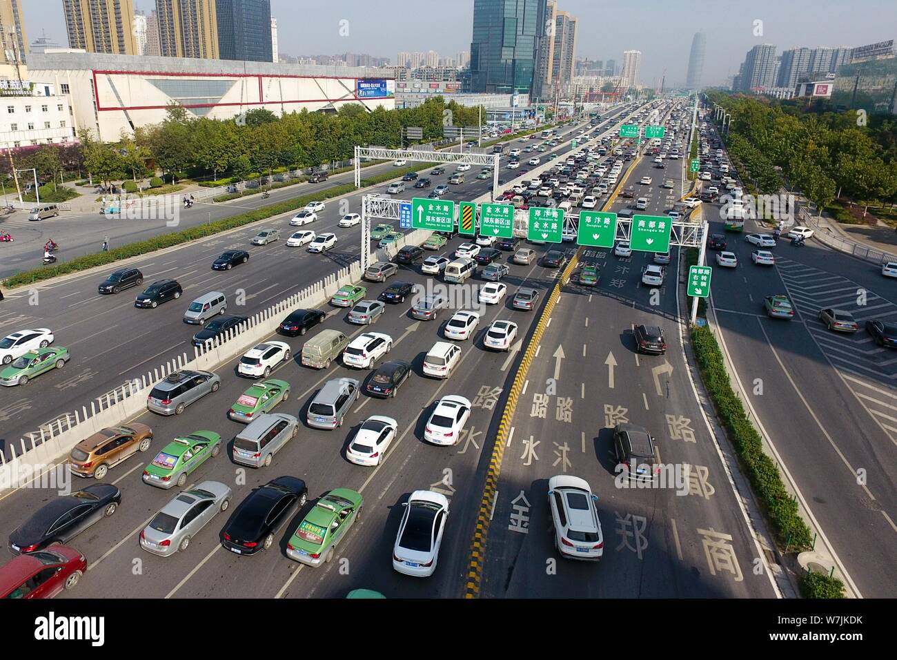 Masses of vehicles move slowly on an elevated highway during a traffic ...
