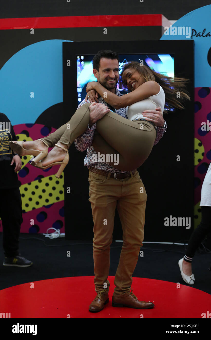 British actor Stuart Reid holds up American singer-songwriter and ...