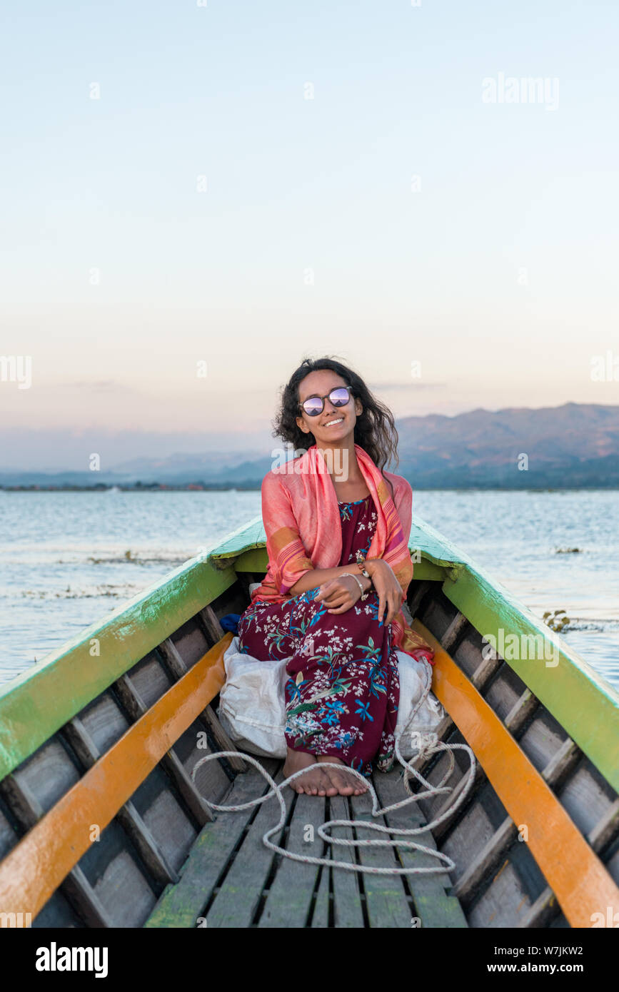 Vertical picture of a beautiful foreigner tourist at touristic boat in ...