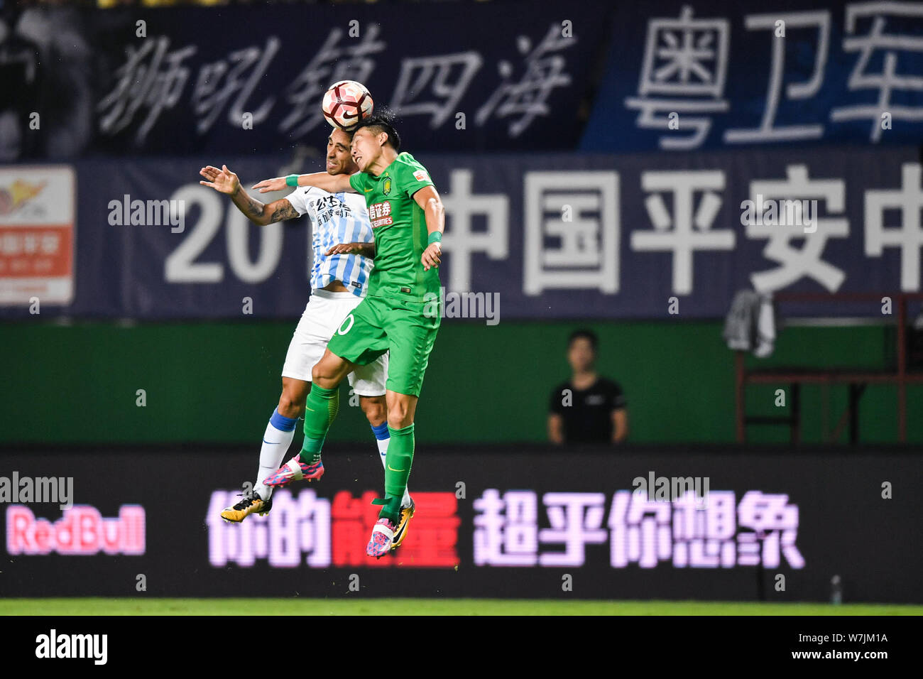 Israeli football player Eran Zahavi, left, of Guangzhou R&F heads the ...