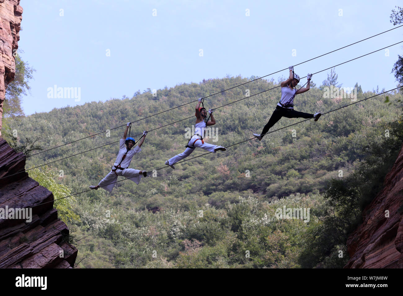 38 Chinese yoga enthusiasts perform yoga on steel wires at a steep ...