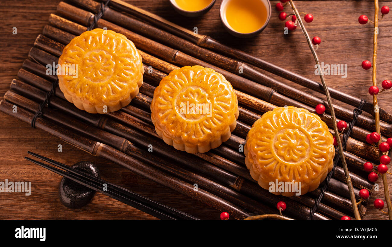 Chinese traditional pastry Moon cake Mooncake with tea cups on bamboo ...