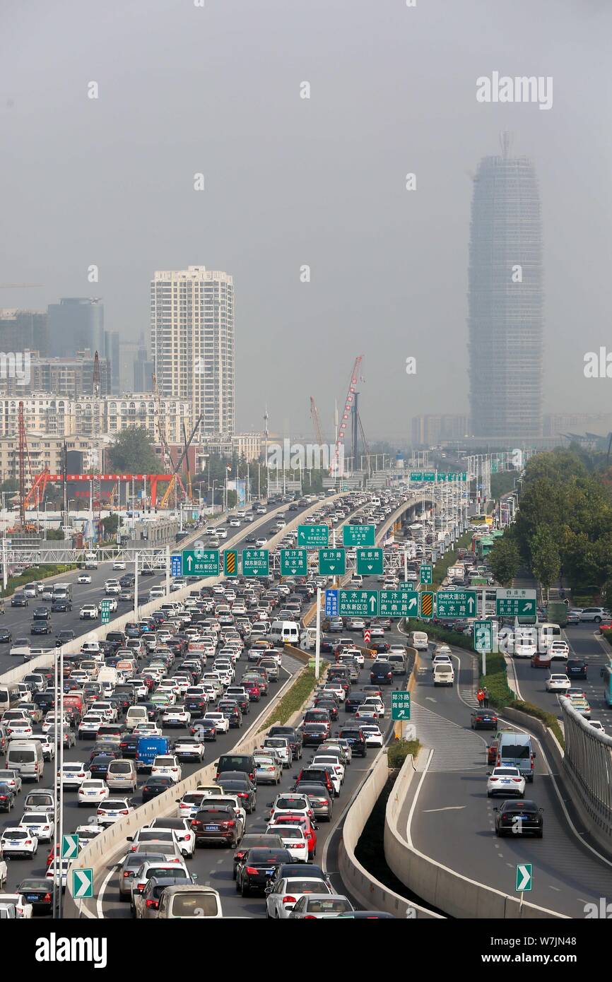 Masses of vehicles move slowly on an elevated highway during a traffic ...