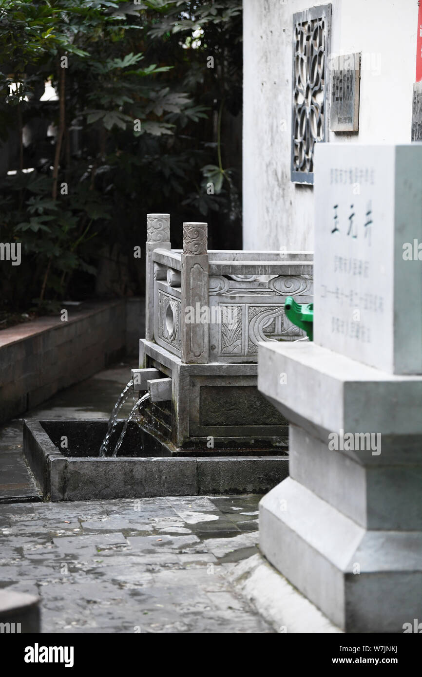 View of the 600-year-old Yujing Ancient Well with well water flowing at ...