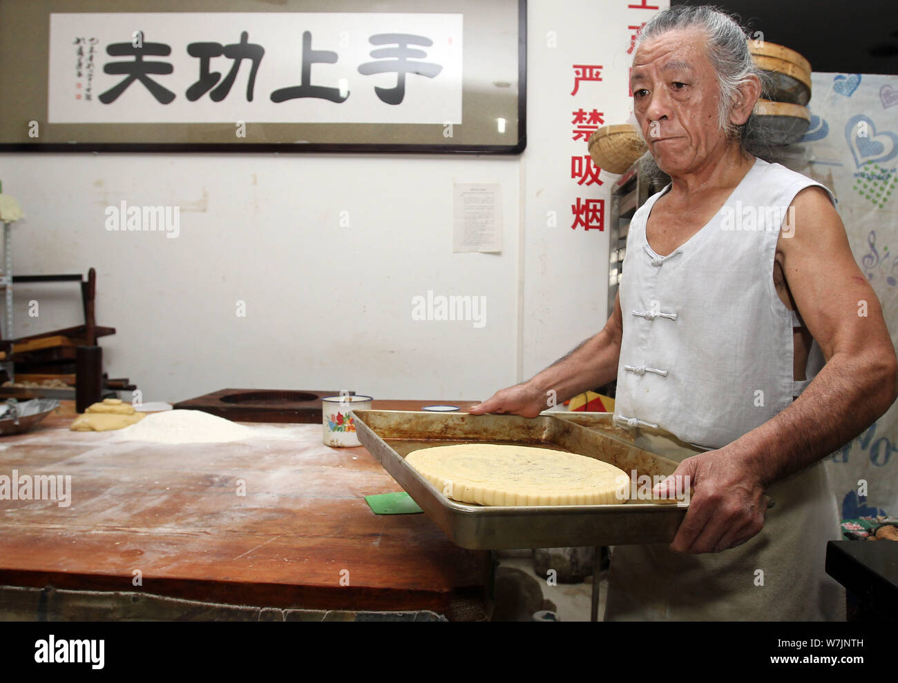 72-year-old Chinese baker Wei Quanfa is making mooncakes at his hand ...