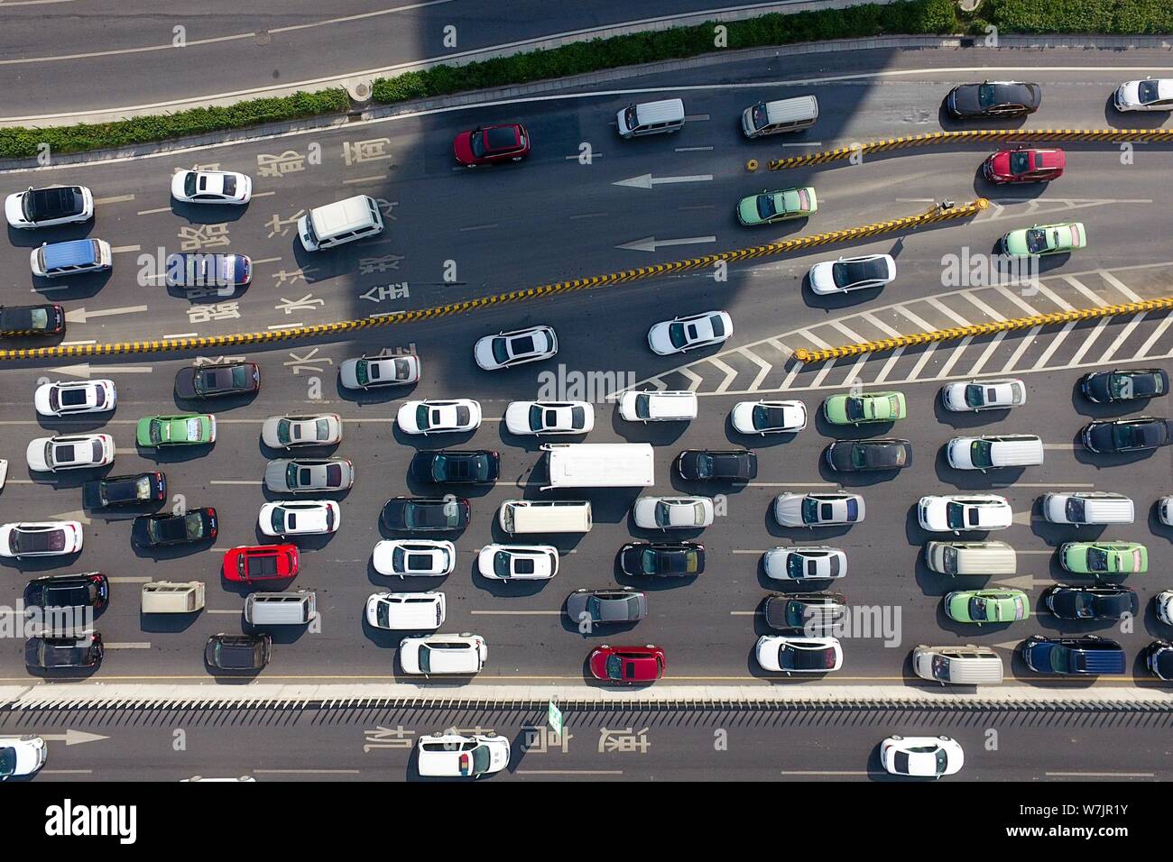 Masses of vehicles move slowly on an elevated highway during a traffic ...