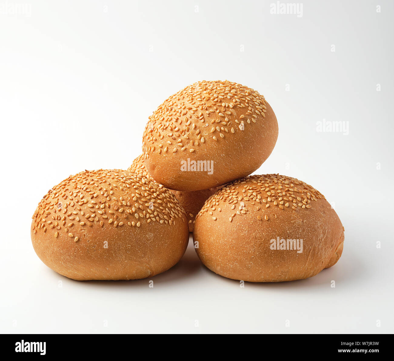 stack of baked whole round bun with sesame seeds made from white wheat ...