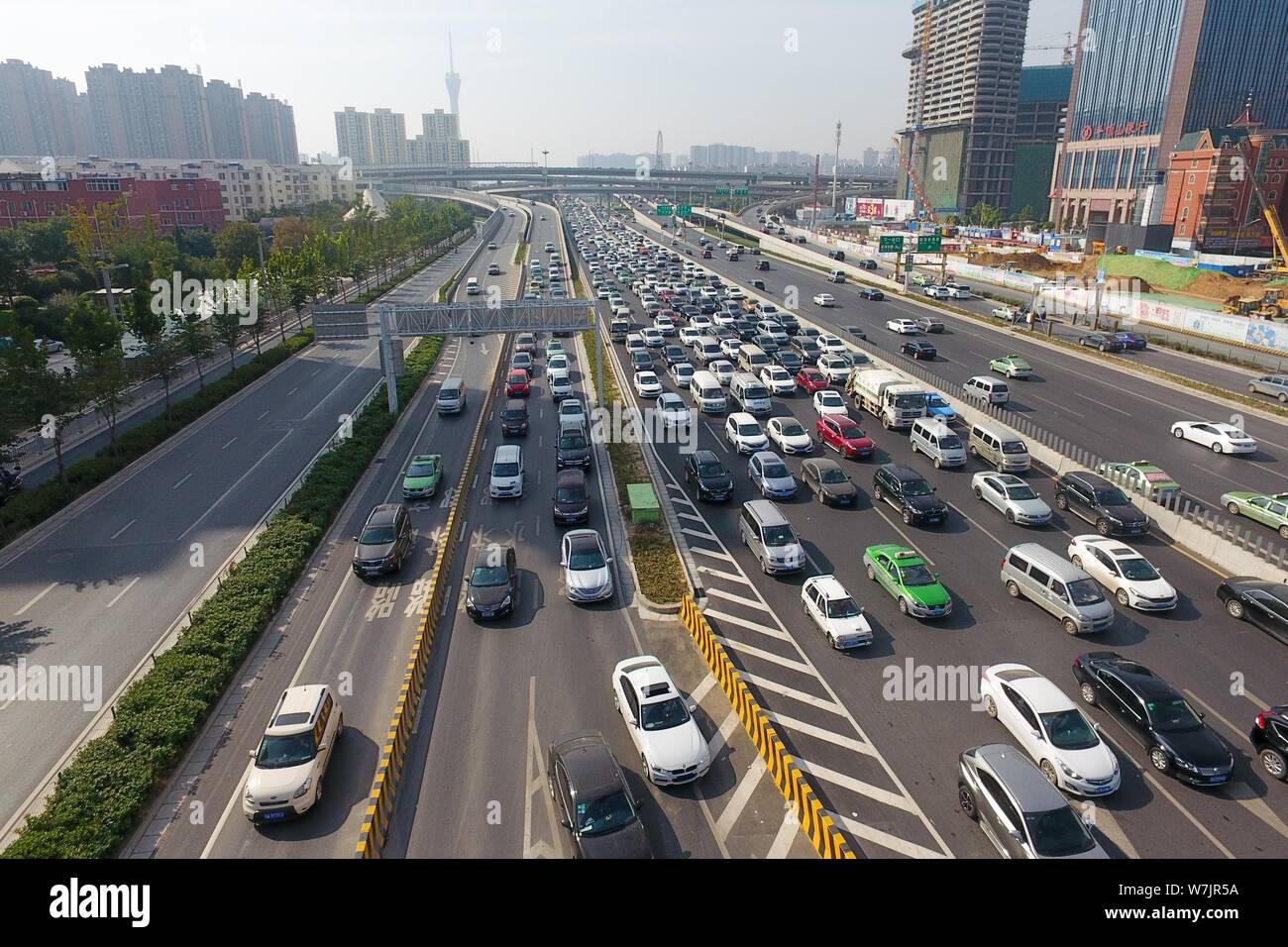 Masses of vehicles move slowly on an elevated highway during a traffic ...