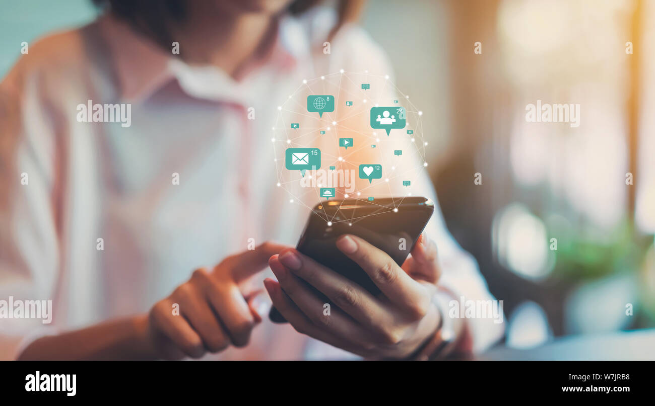 Woman hand using smartphone and show technology icon social media ...