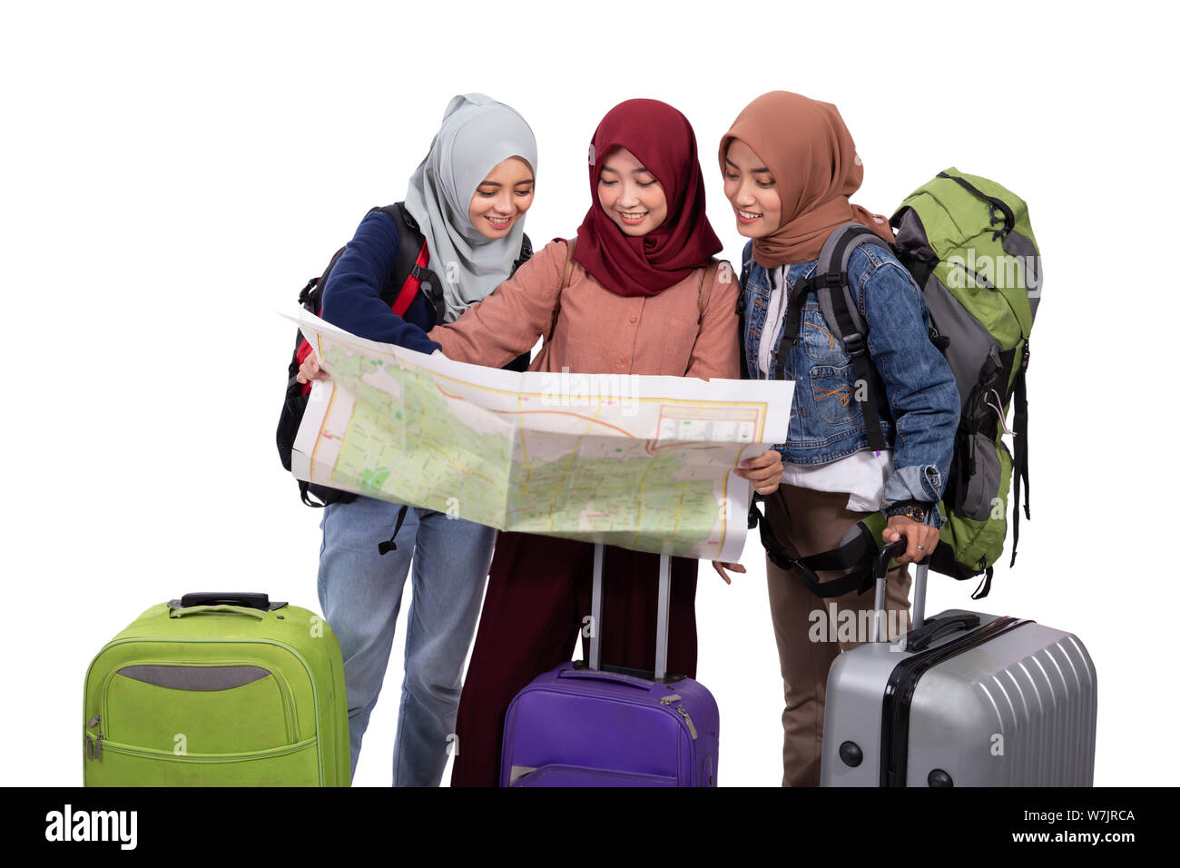Three hijab traveller holding a map find a holiday destination Stock ...