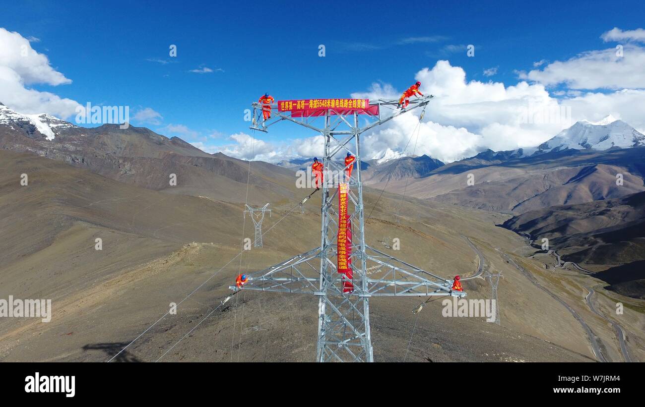 Electricity workers labour on the world's highest power transmission ...