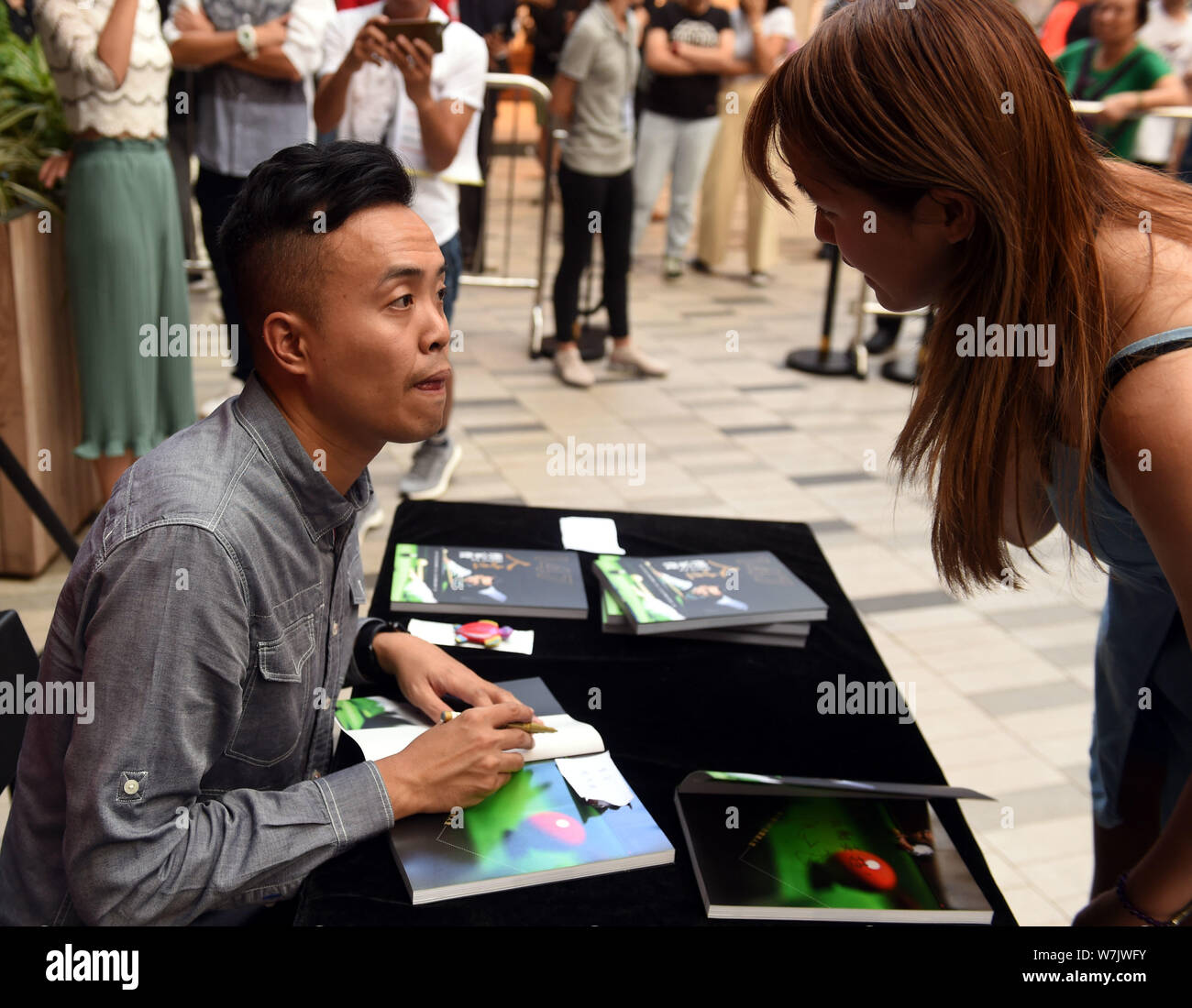 Hong Kong snooker player Marco Fu, left, talks with a fan during a ...